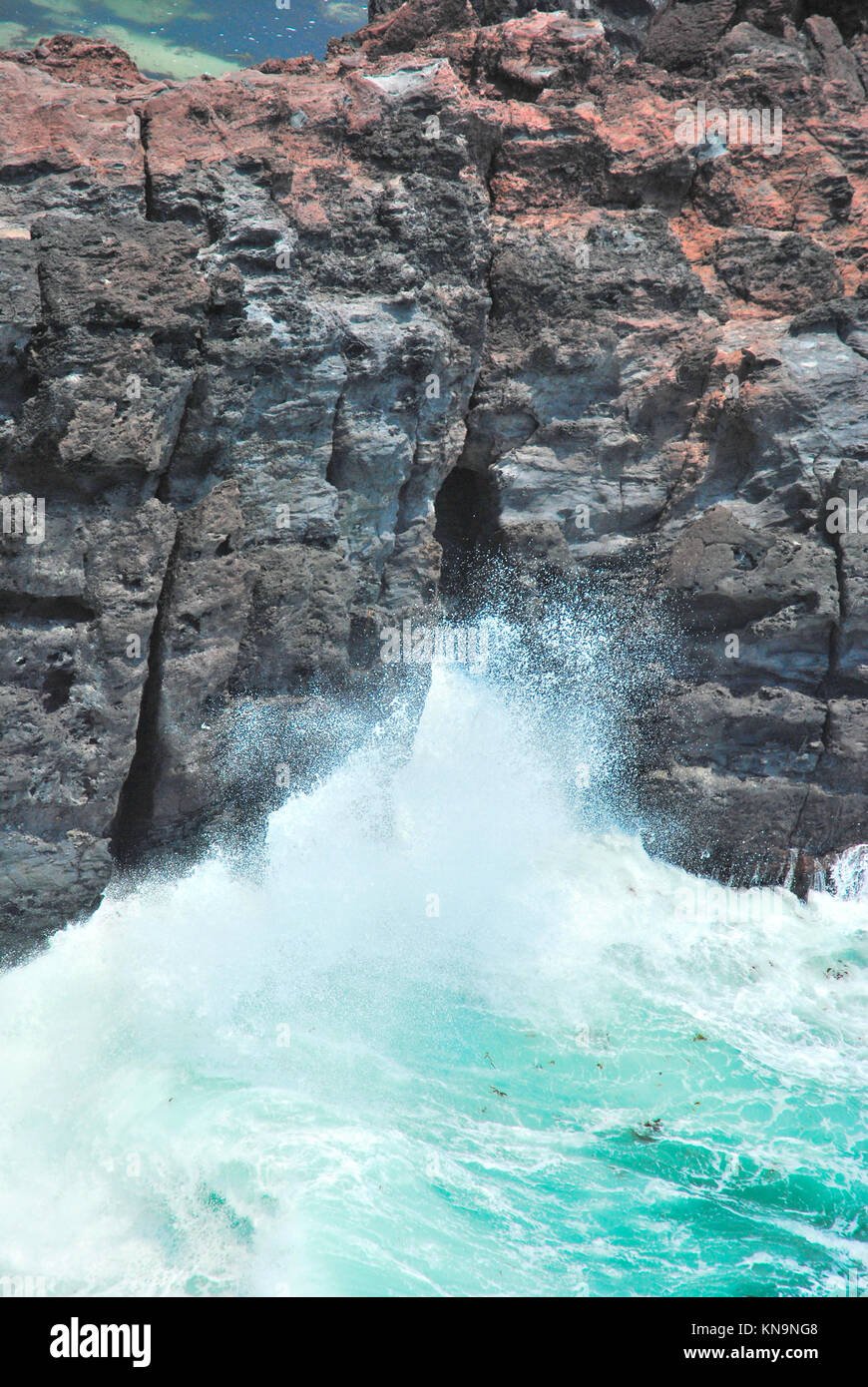 Treacherous waves splashing on cliff rocks, displaying the power and ...