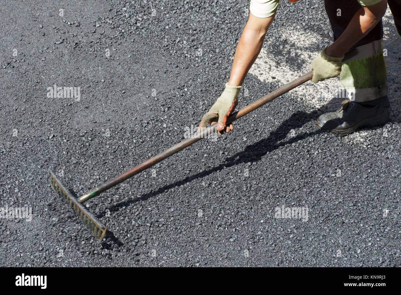Worker at asphalting works a street Stock Photo - Alamy