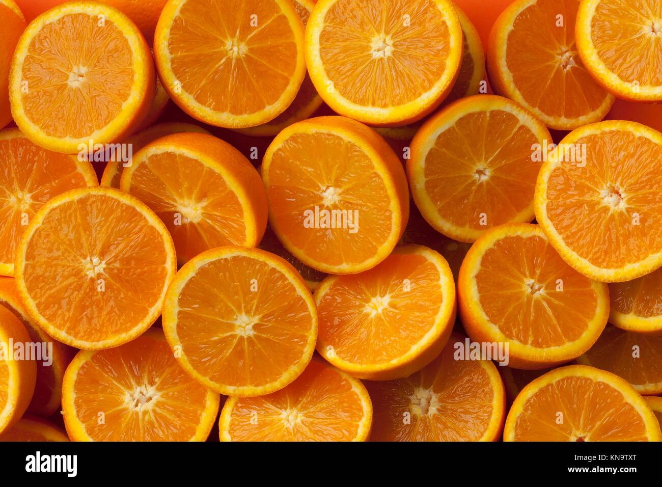 Fresh cut half oranges full frame close up Stock Photo - Alamy