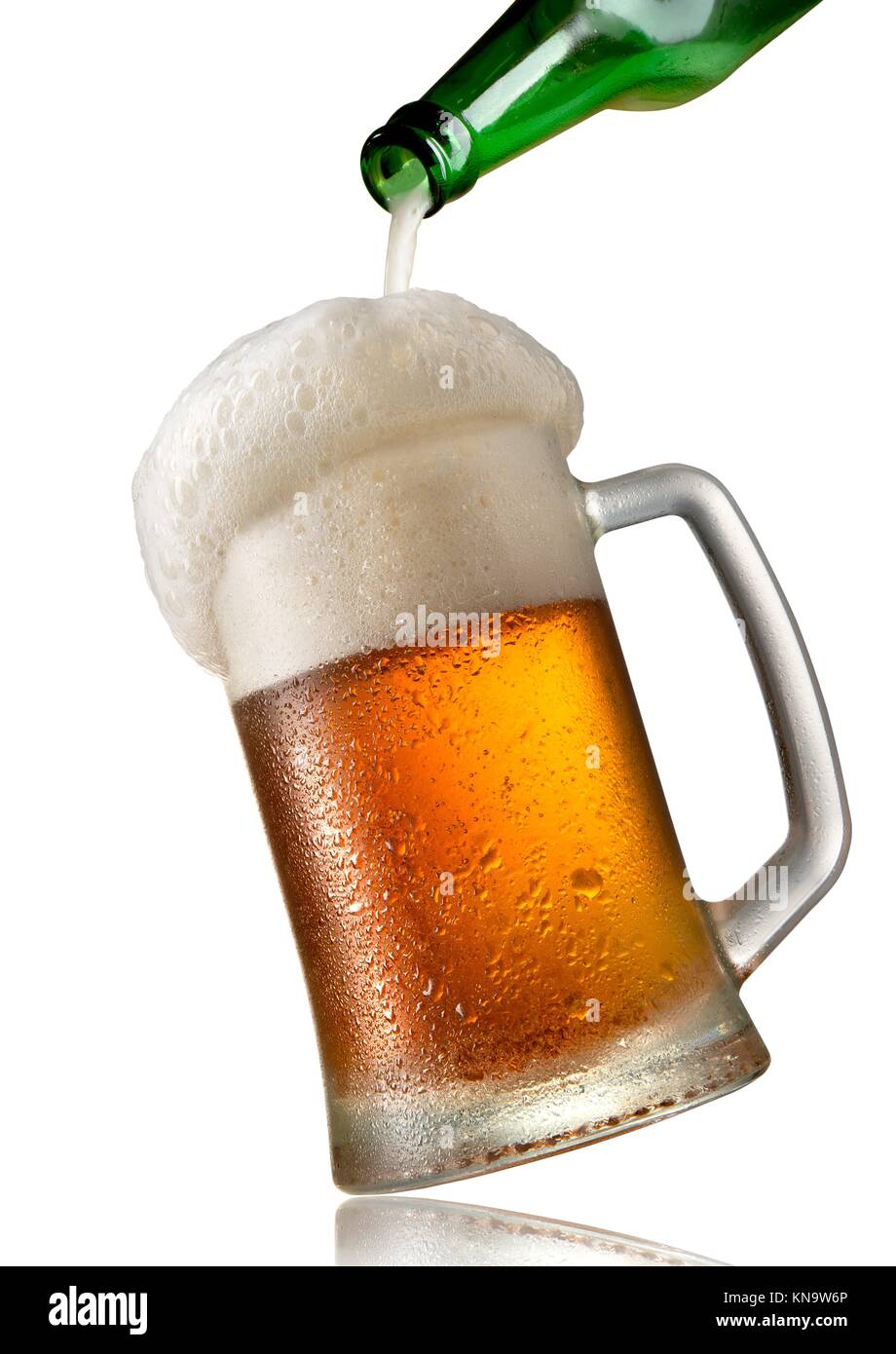 Beer pouring into mug isolated on a white background Stock Photo - Alamy