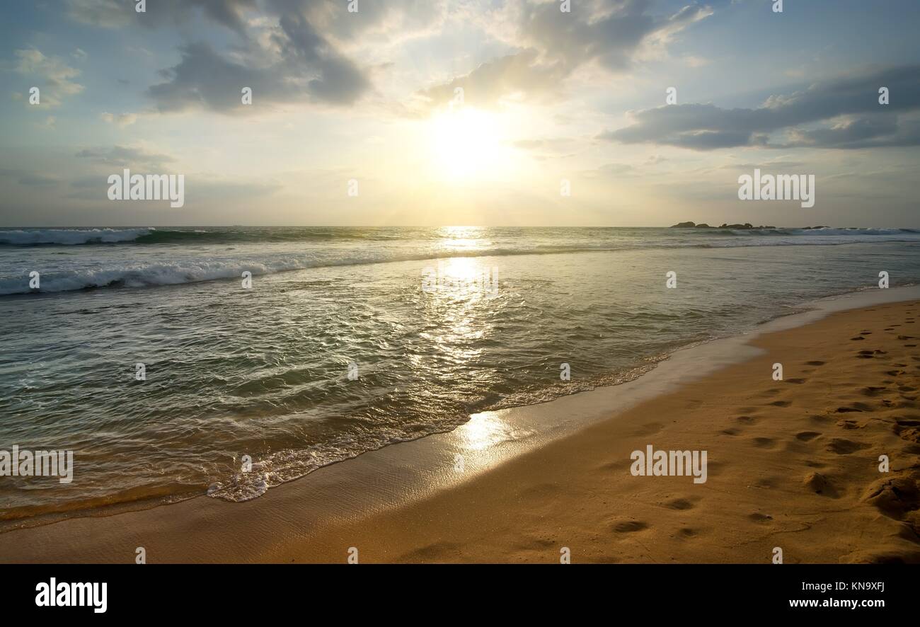 Beautiful sunset over sandy beach of Indian ocean Stock Photo - Alamy