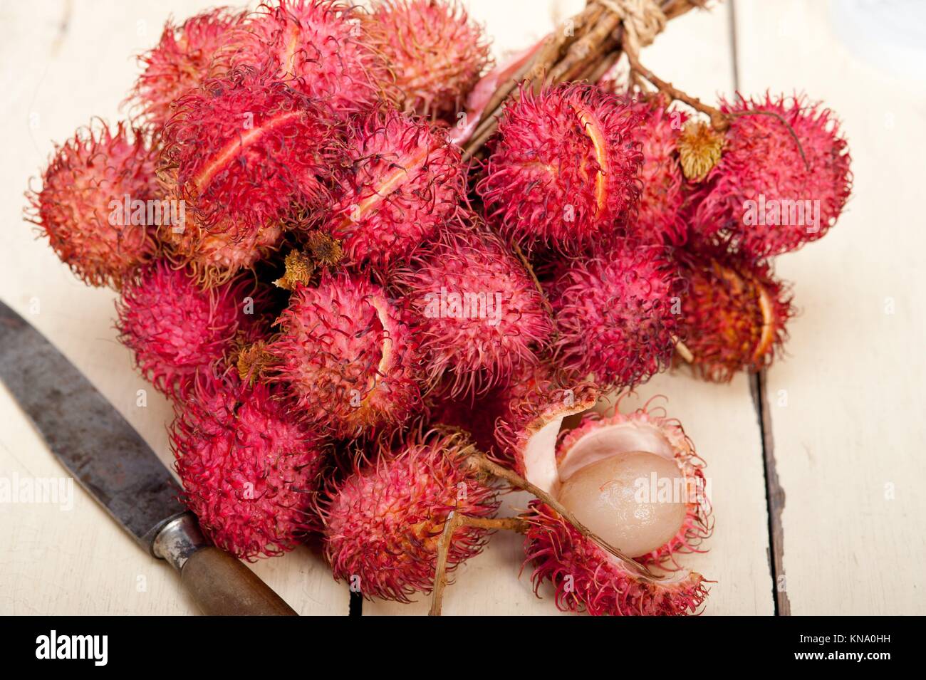 fresh tropical rambutan fruits over rustic wood table Stock Photo - Alamy