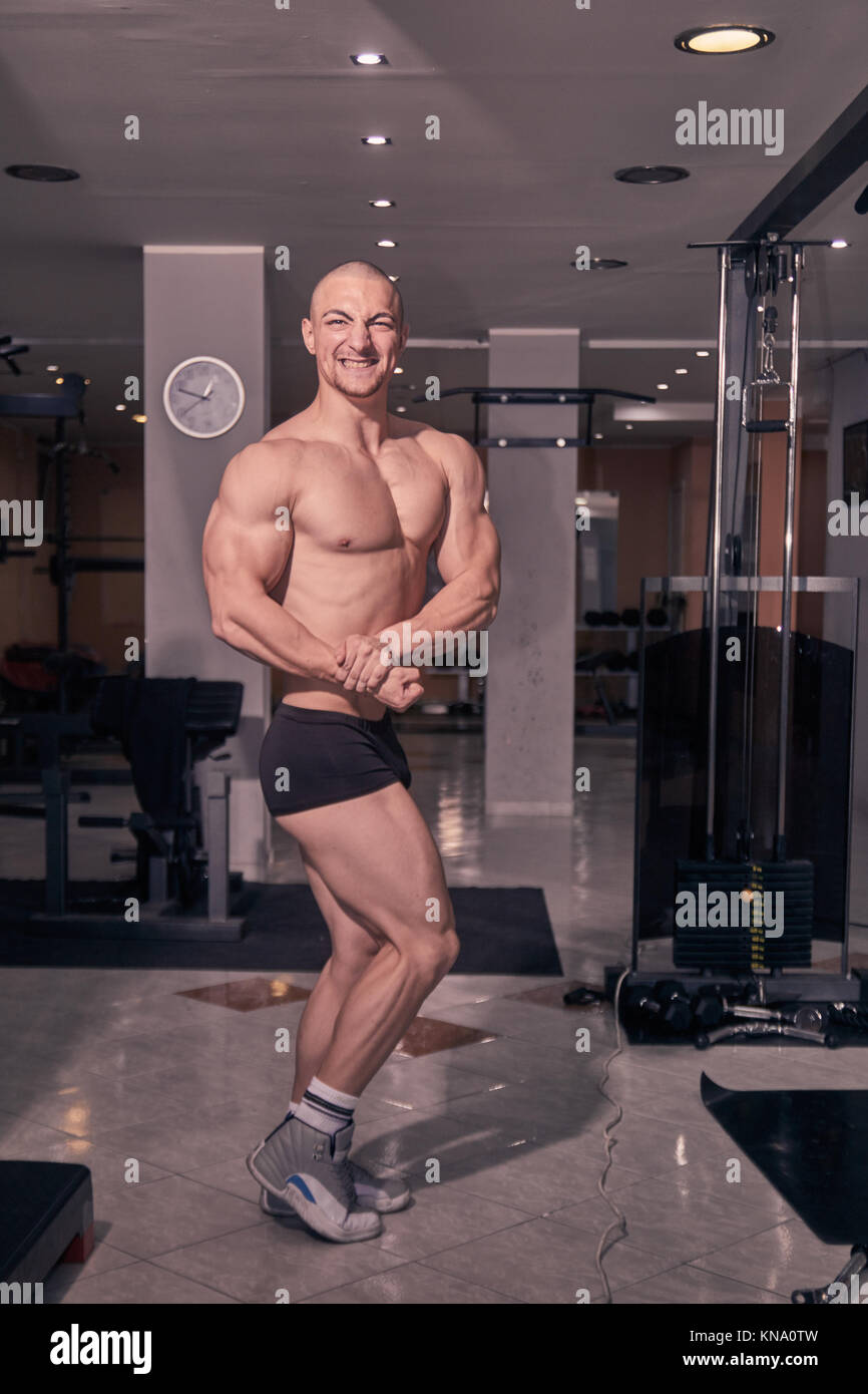 one young bodybuilder tense tough posing, muscular strong, fitness ...