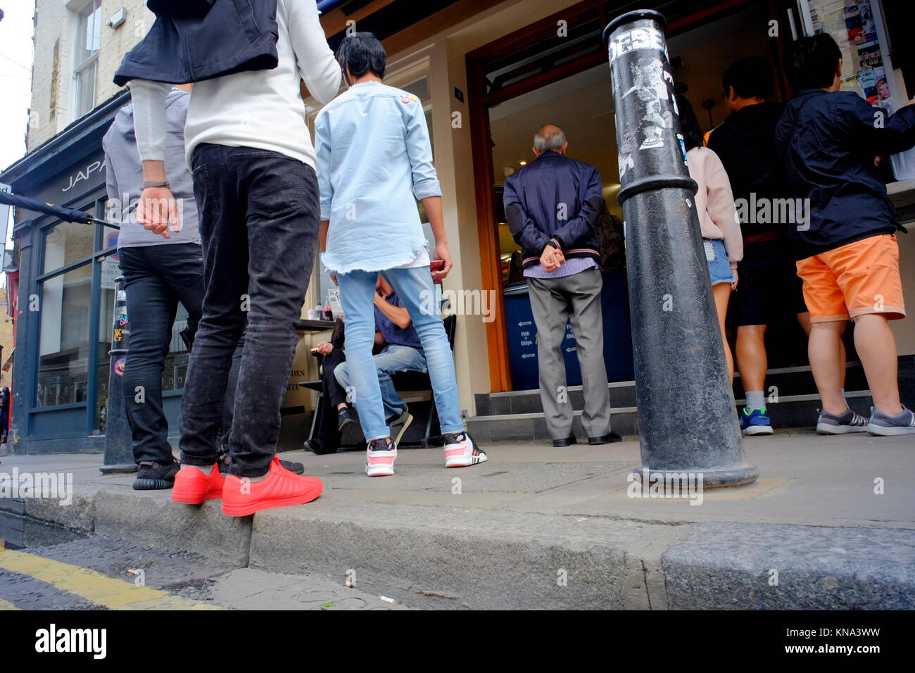 People waiting outside restaurant on Brick Lane in Shoreditch, London ...