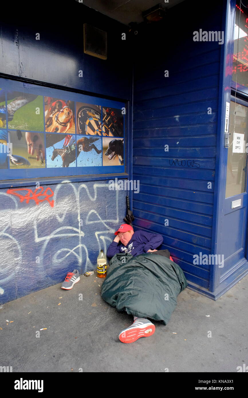 homeless woman sleeping by betting shop in Shoreditch, London, England ...