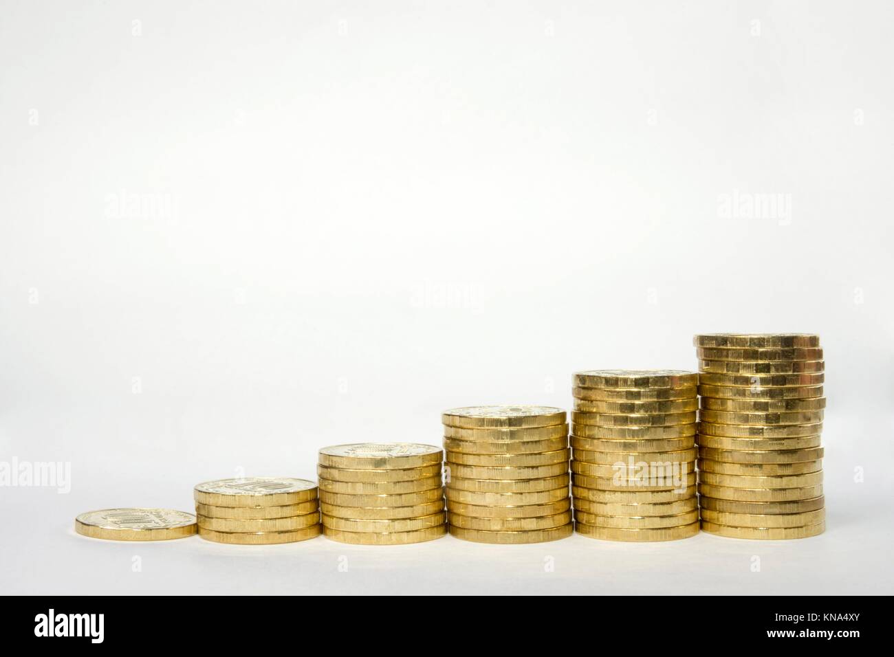 Revenue growth as shown by the example of coins columns Stock Photo - Alamy