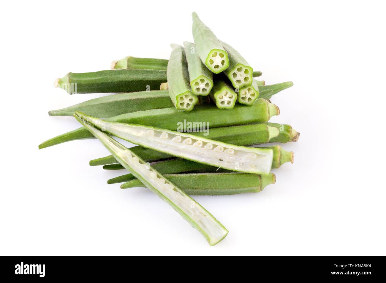 Okra pods whole and sectioned, isolated on white background Stock Photo ...