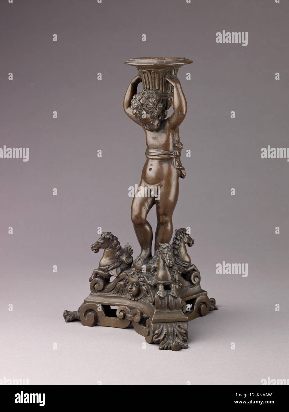 This candlestick is designed in the form of a putto, a classical figure ...