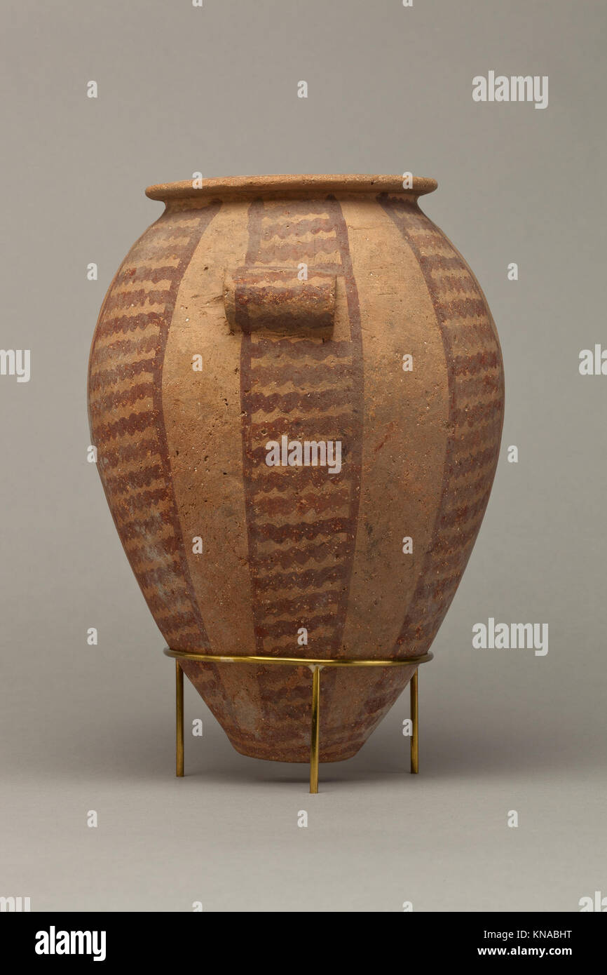 This decorated jar, featuring vertical bands of wavy lines, represents ...