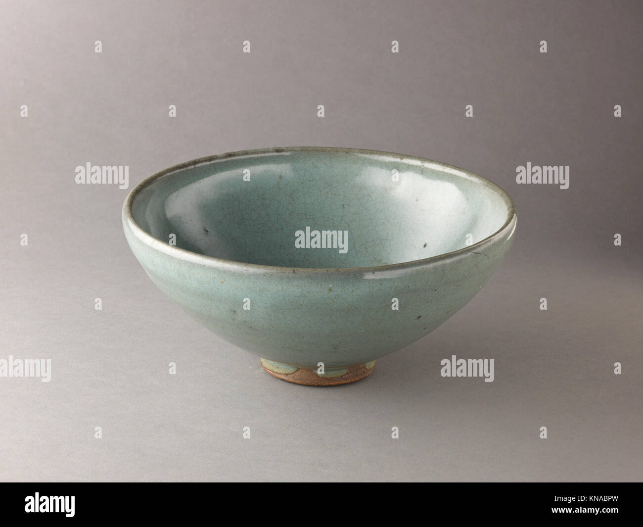This deep bowl, crafted from Jun ware, features the distinctive glaze ...
