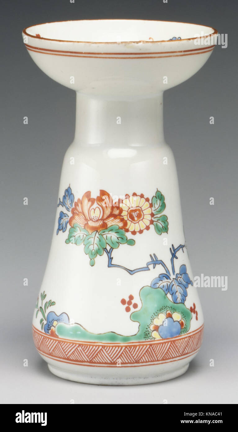 This candlestick, made from metal, features a detailed and functional ...