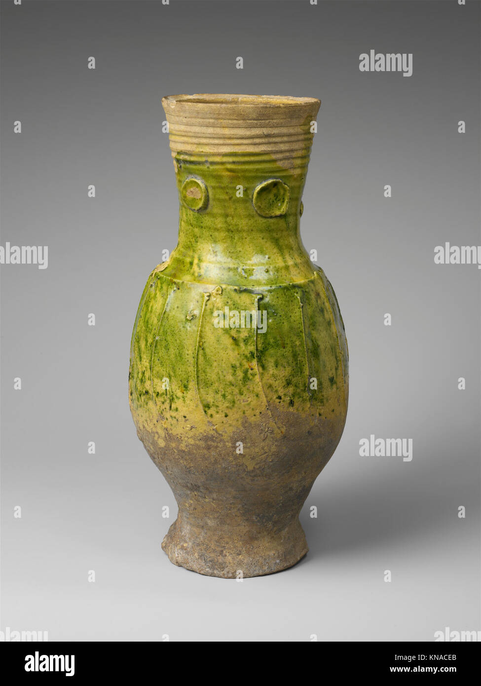 This green-glazed pitcher features intricate pottery design, showcasing ...