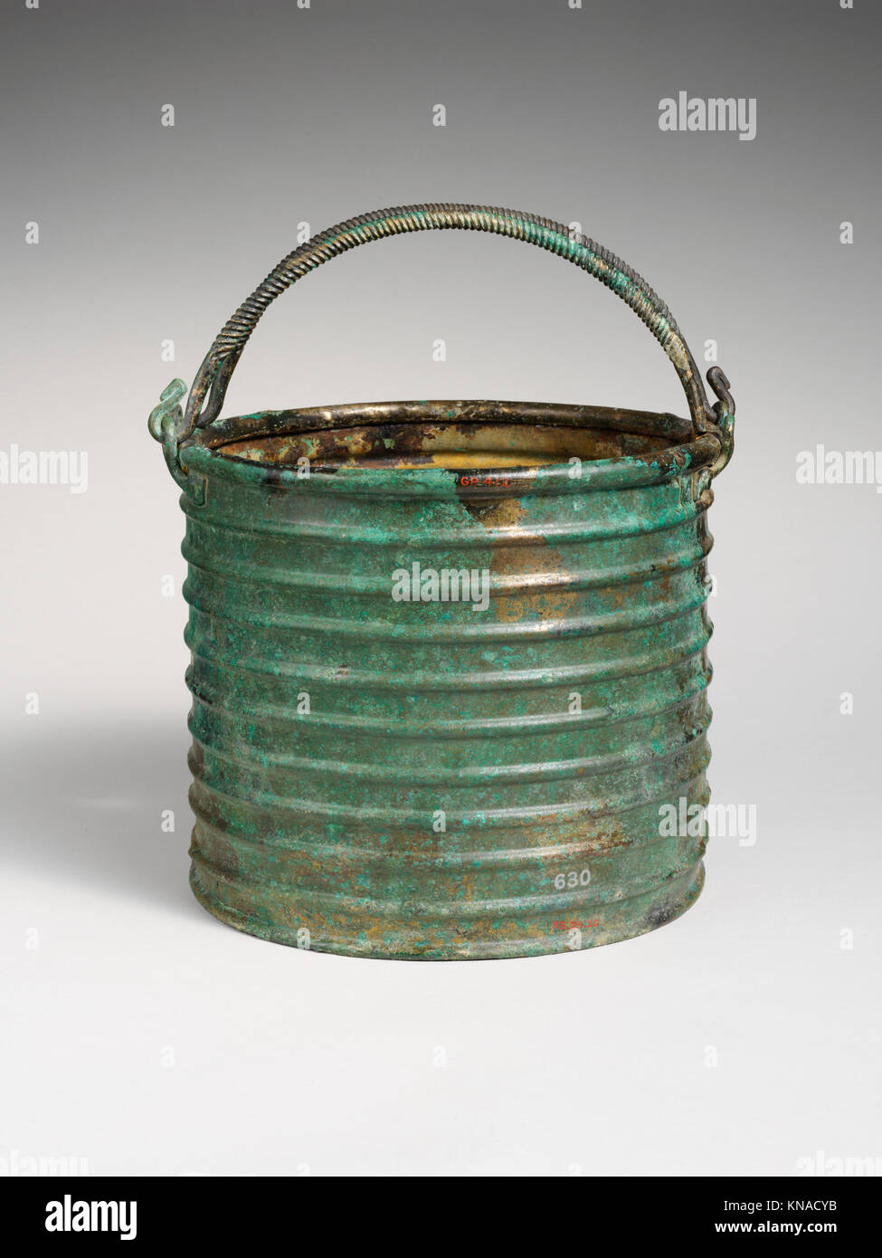 This bronze ribbed situla is an ancient bucket-like vessel with two ...