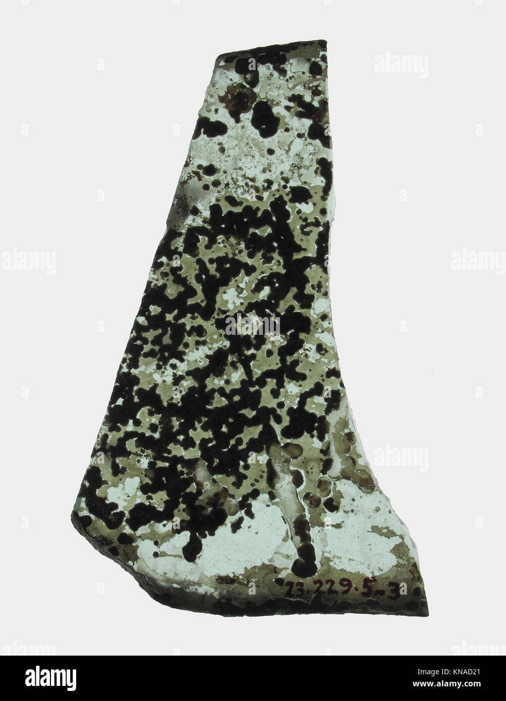 A fragment of glass, part of a larger object, offering insight into ...