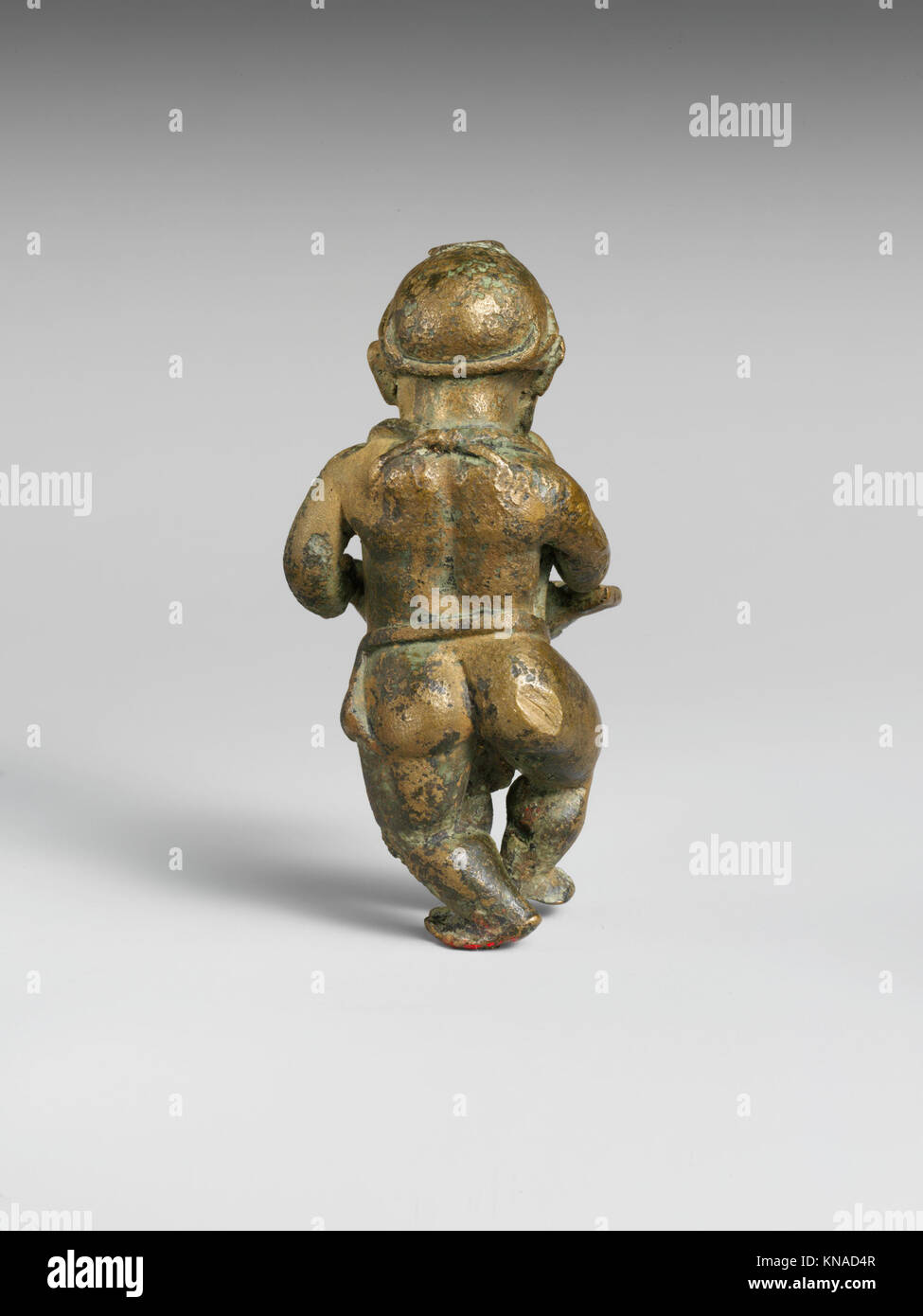 This bronze statuette depicts a dwarf figure with silver eyes, a ...