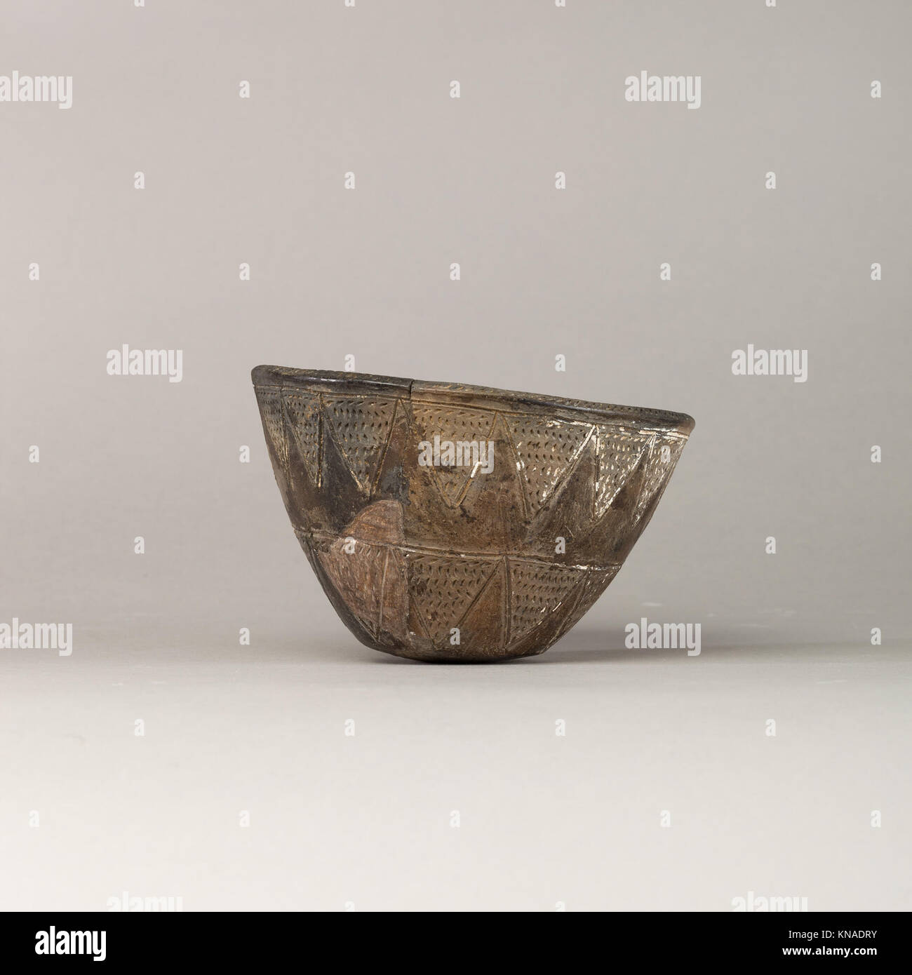 A black incised ware bowl, featuring intricate designs, part of an ...