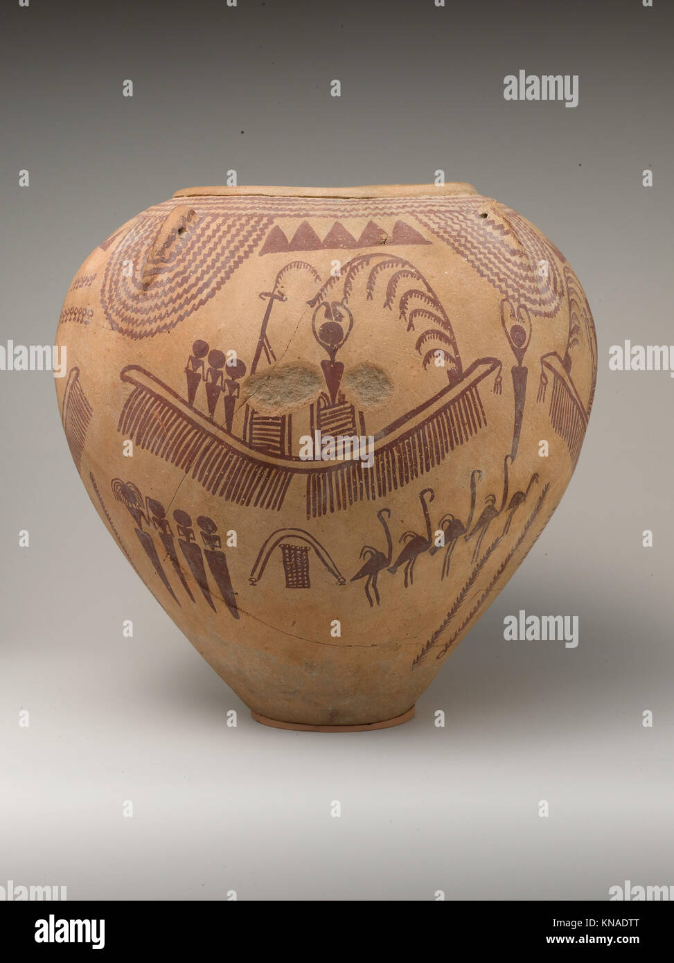 This decorated jar shows designs of ungulates, boats, and human figures ...