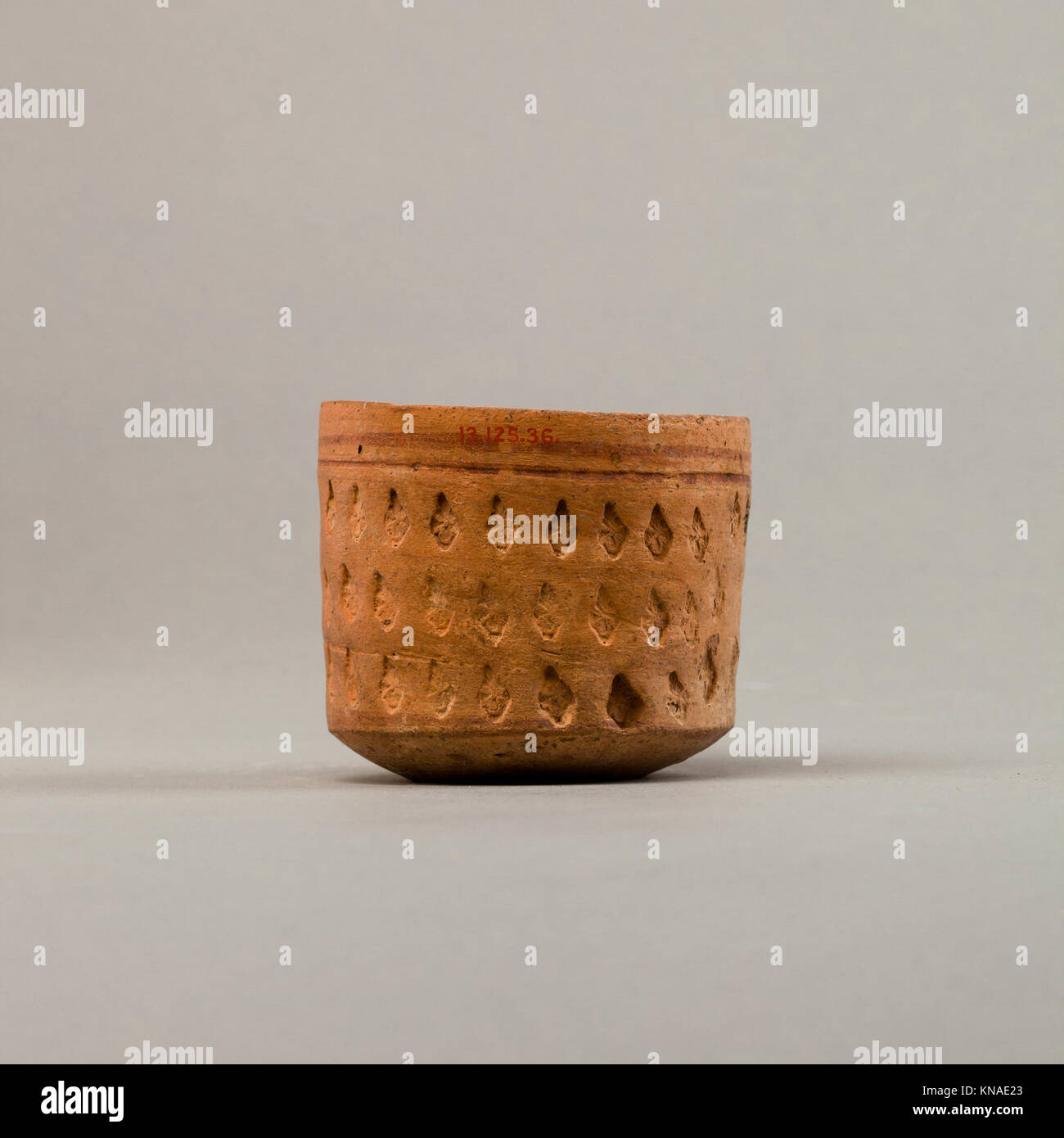 This cup features three rows of impressed decoration, illustrating the ...