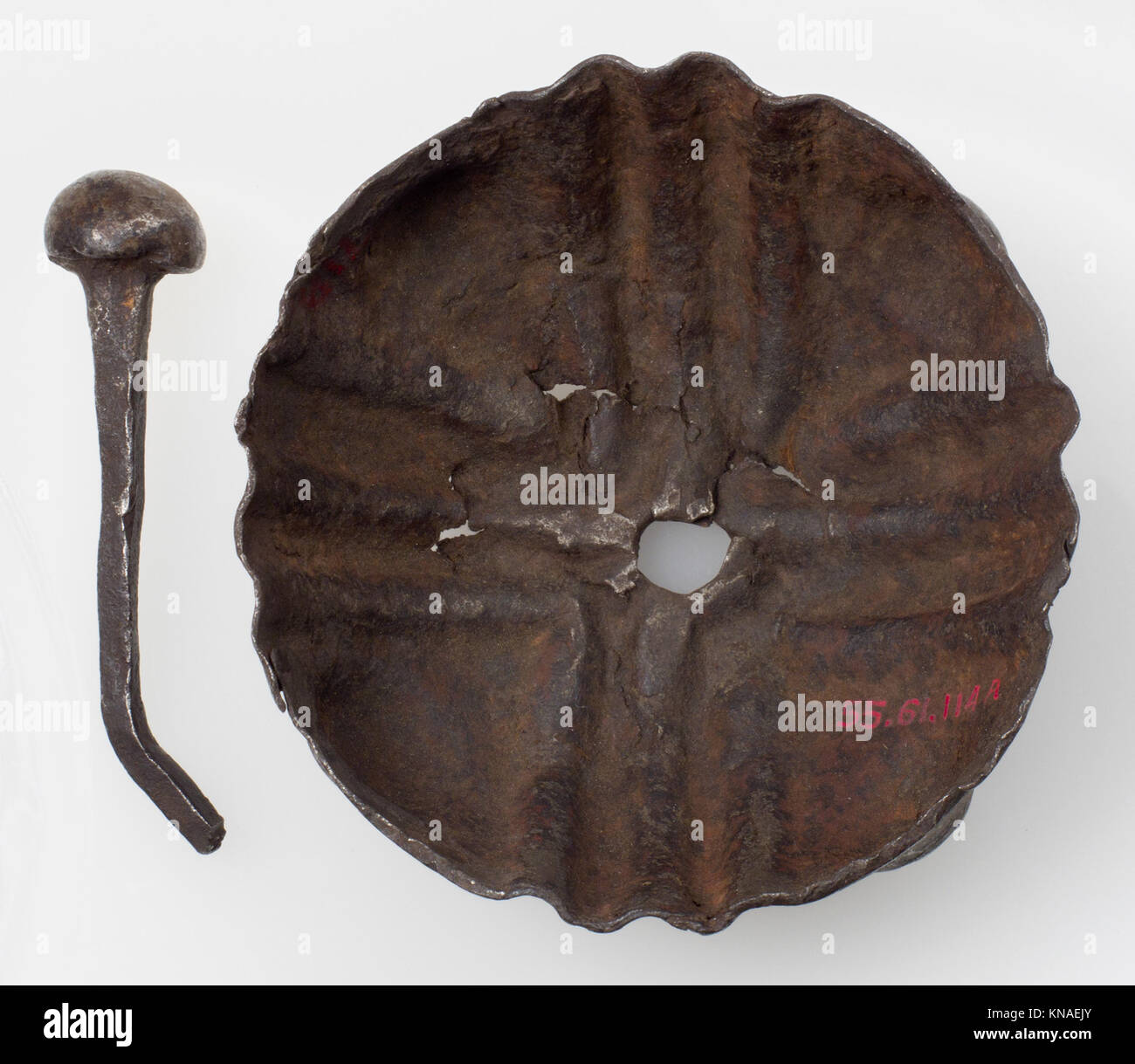 This item consists of a boss and nail, both typical components of ...