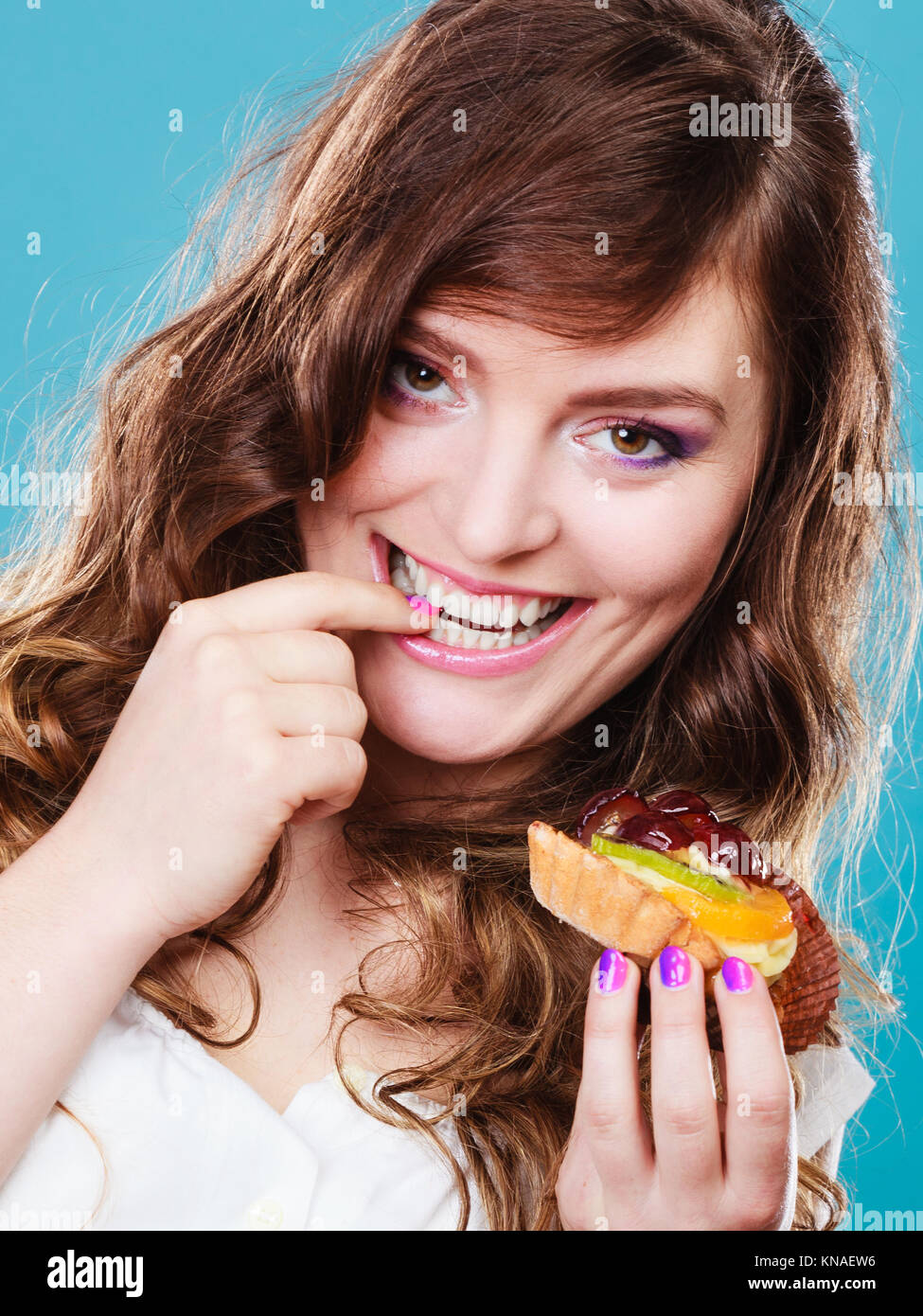 Bakery, sweet food and people concept. Closeup smiling cute woman curly ...