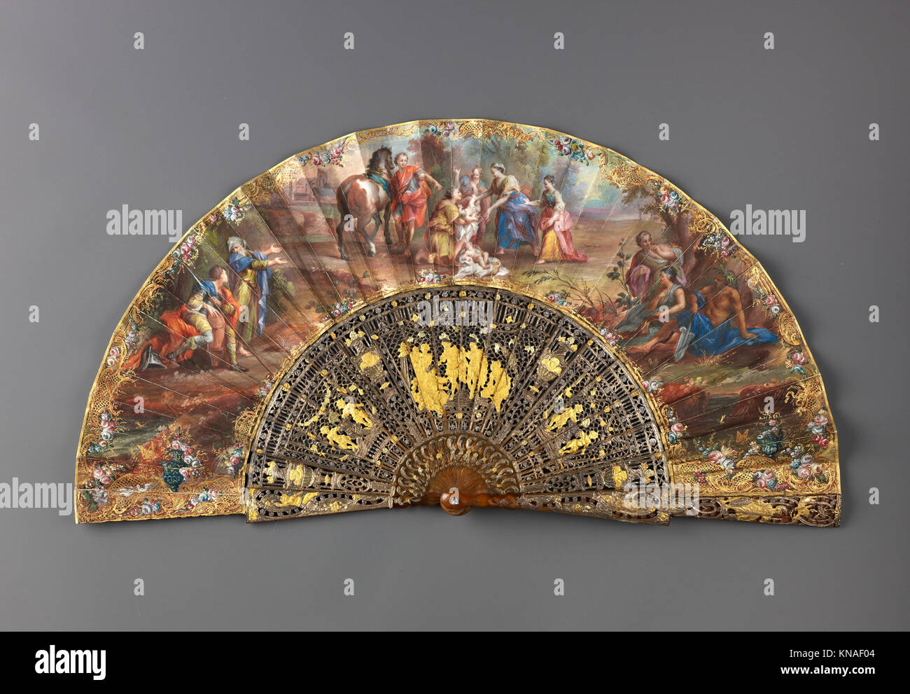 This folding fan features the scene of Romulus and Remus being ...