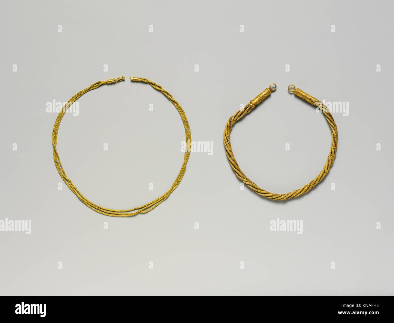 This gold chain features three intertwined strands, offering a layered ...