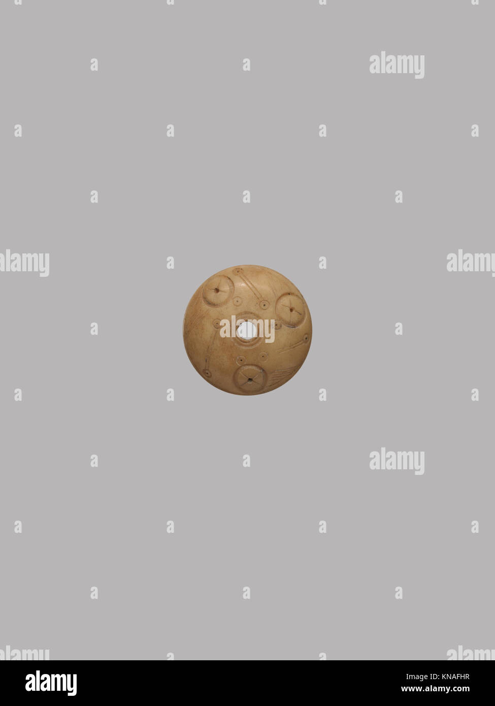 This object, possibly a button, bead, or spindle whorl, demonstrates ...