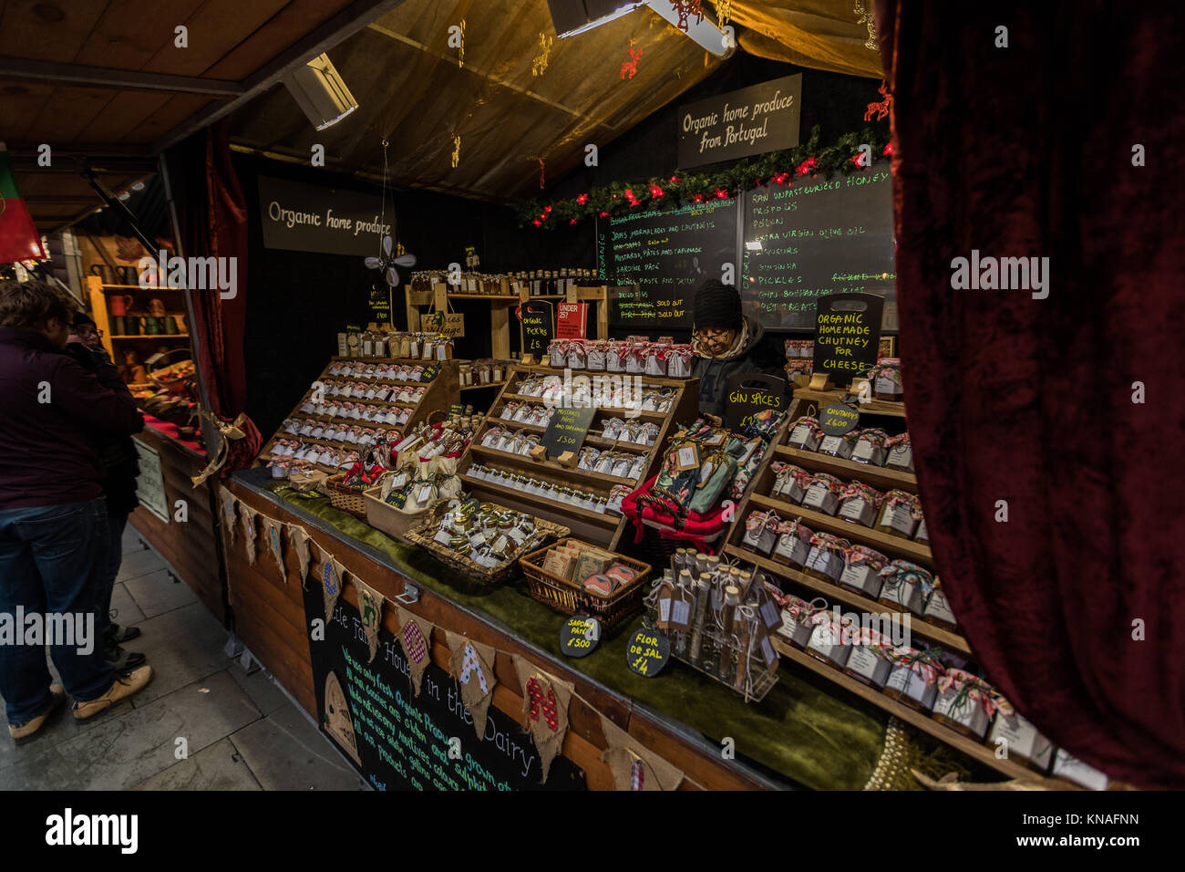 Market stall traders serve food and drink to customers at Manchester ...