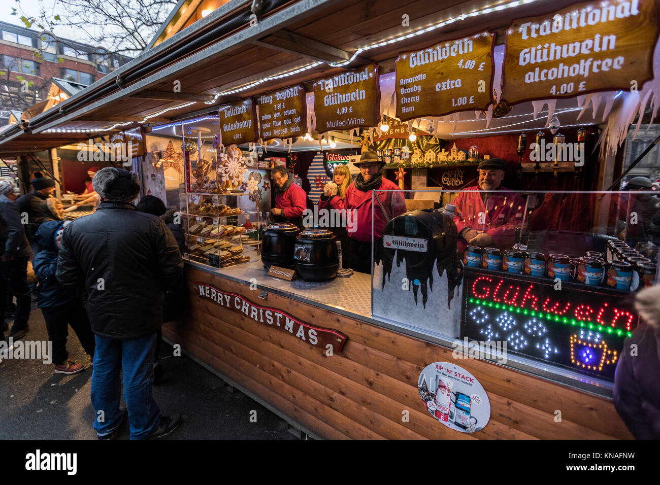Market stall traders serve food and drink to customers at Manchester ...