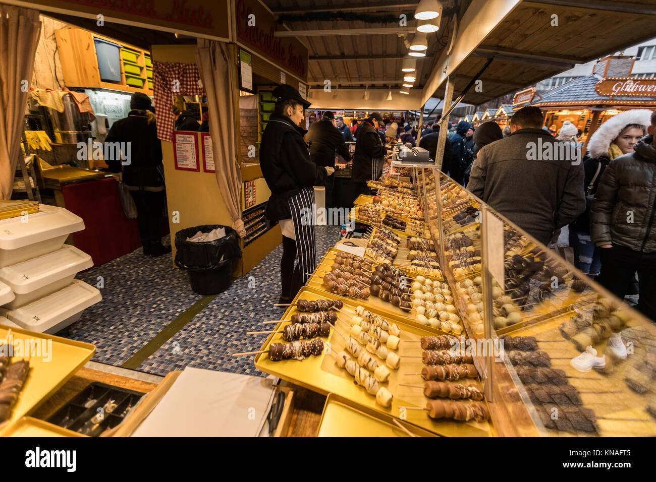 Market stall traders serve food and drink to customers at Manchester ...