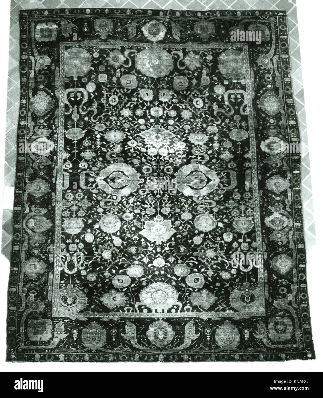 This carpet features a vine scroll and palmette pattern, representing ...