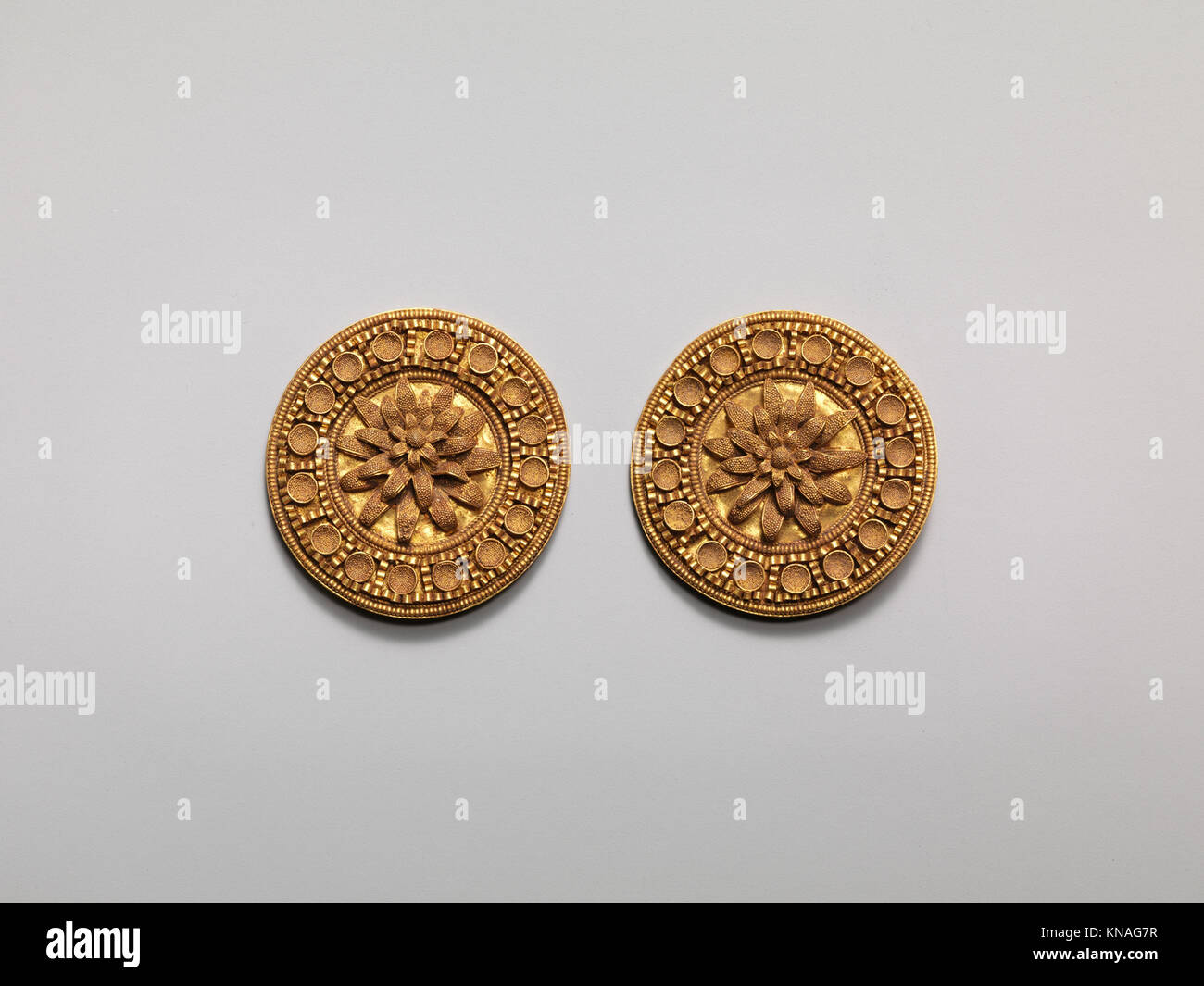 These ancient metal earring disks demonstrate jewelry craftsmanship ...