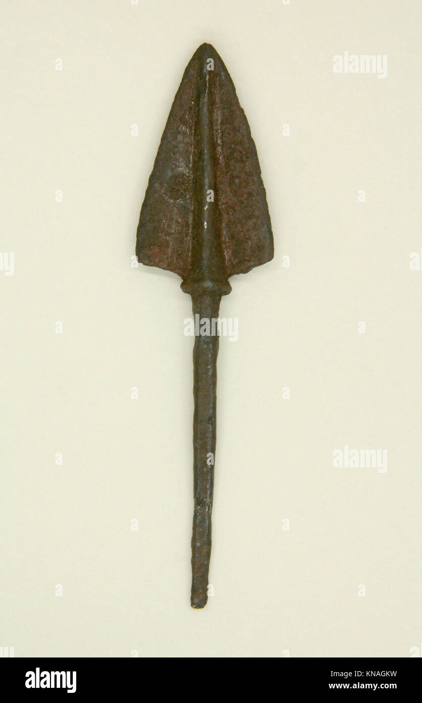 A stone arrowhead representing ancient projectile technology ...