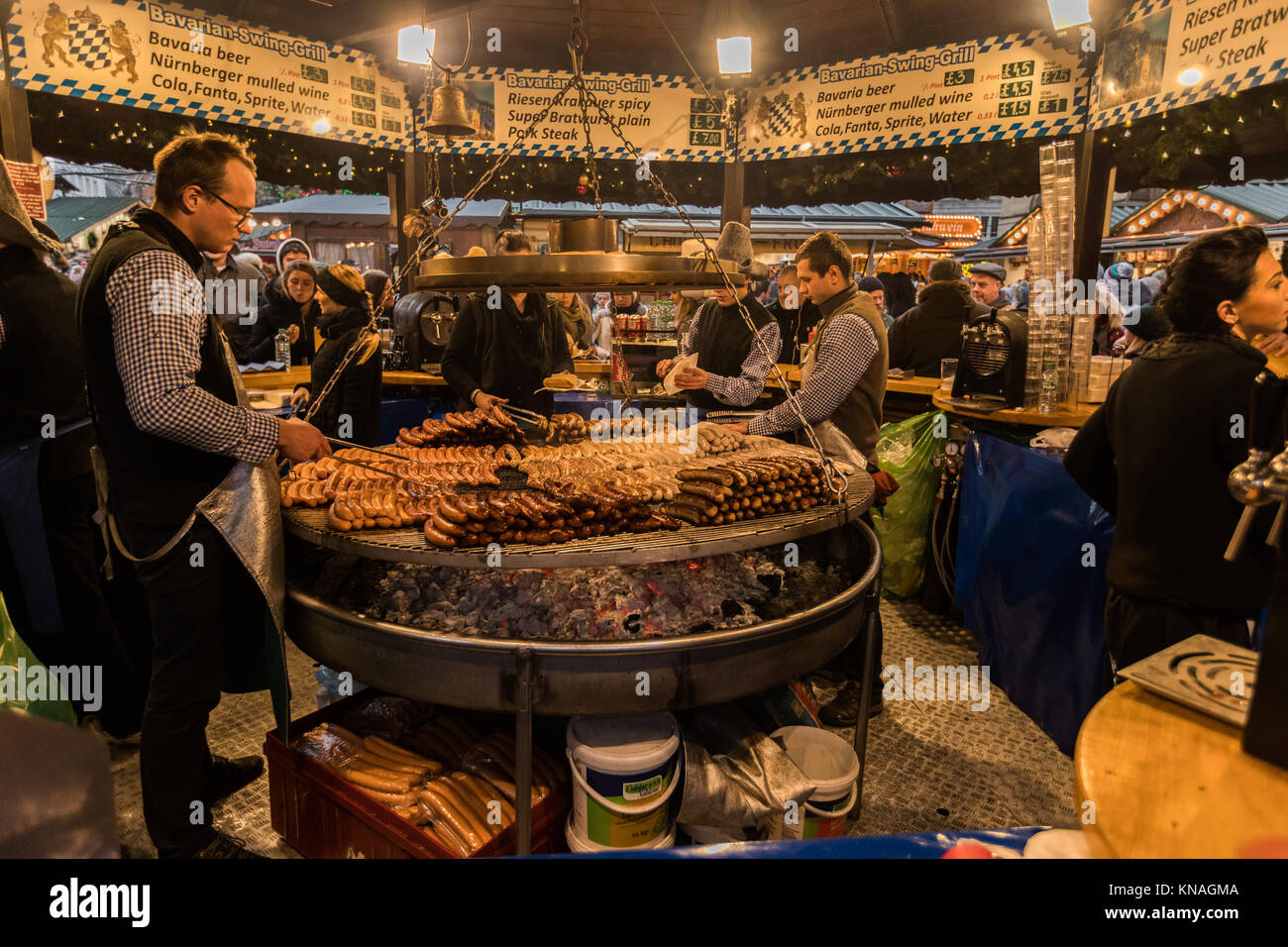 Market stall traders serve food and drink to customers at Manchester ...