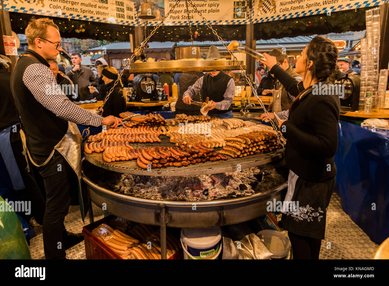 Market stall traders serve food and drink to customers at Manchester ...
