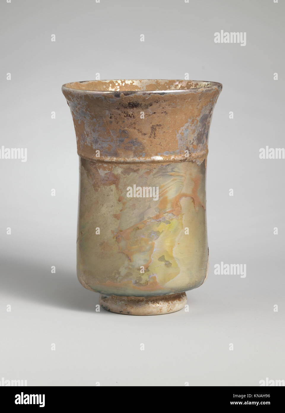 This Roman glass beaker, dating from the 4th century A.D., features a ...