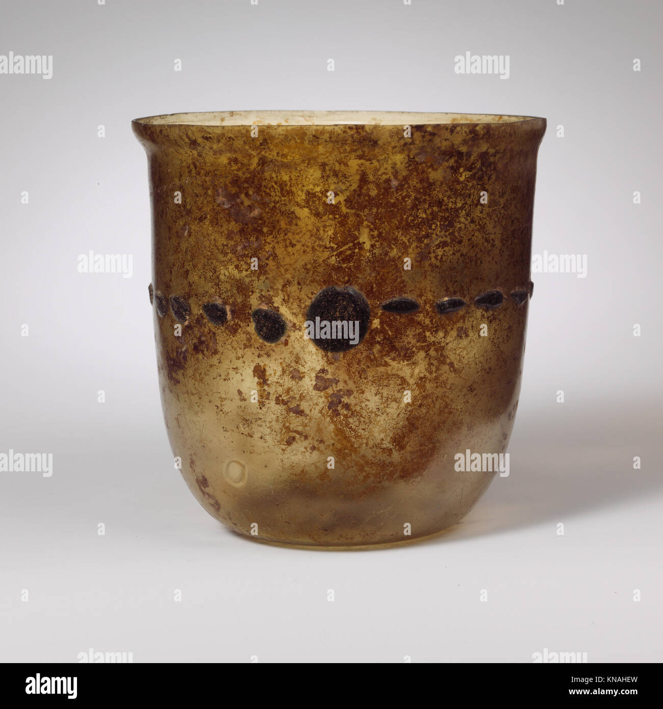 This Roman glass beaker (1st–2nd century A.D.) features translucent ...