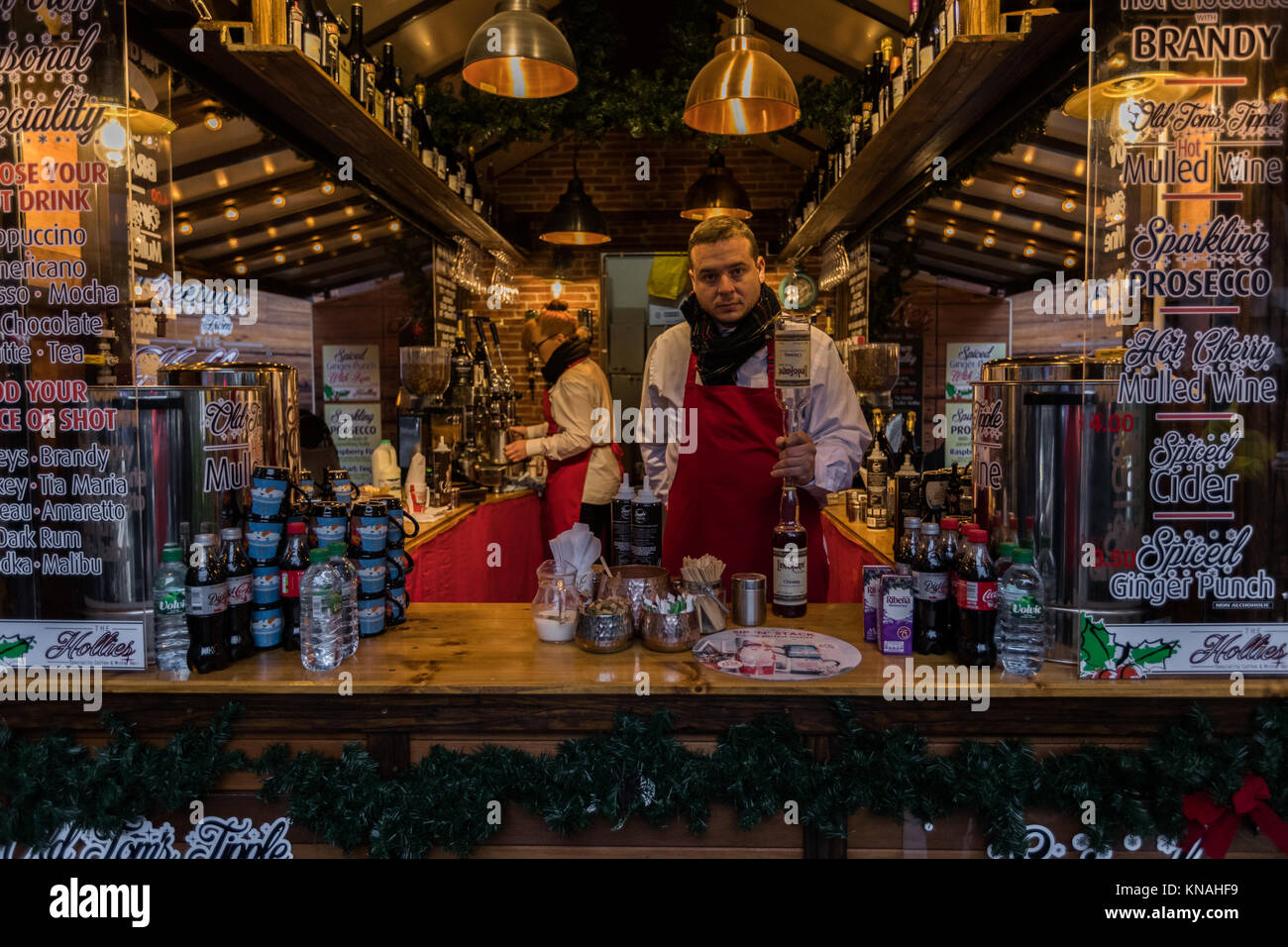Market stall traders serve food and drink to customers at Manchester ...