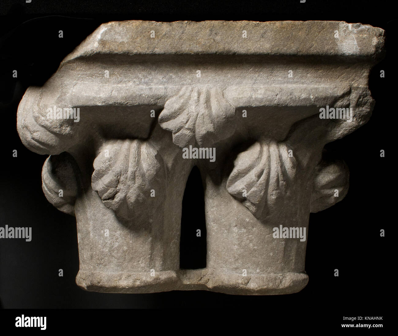 This artifact features a double capital, a type of architectural ...
