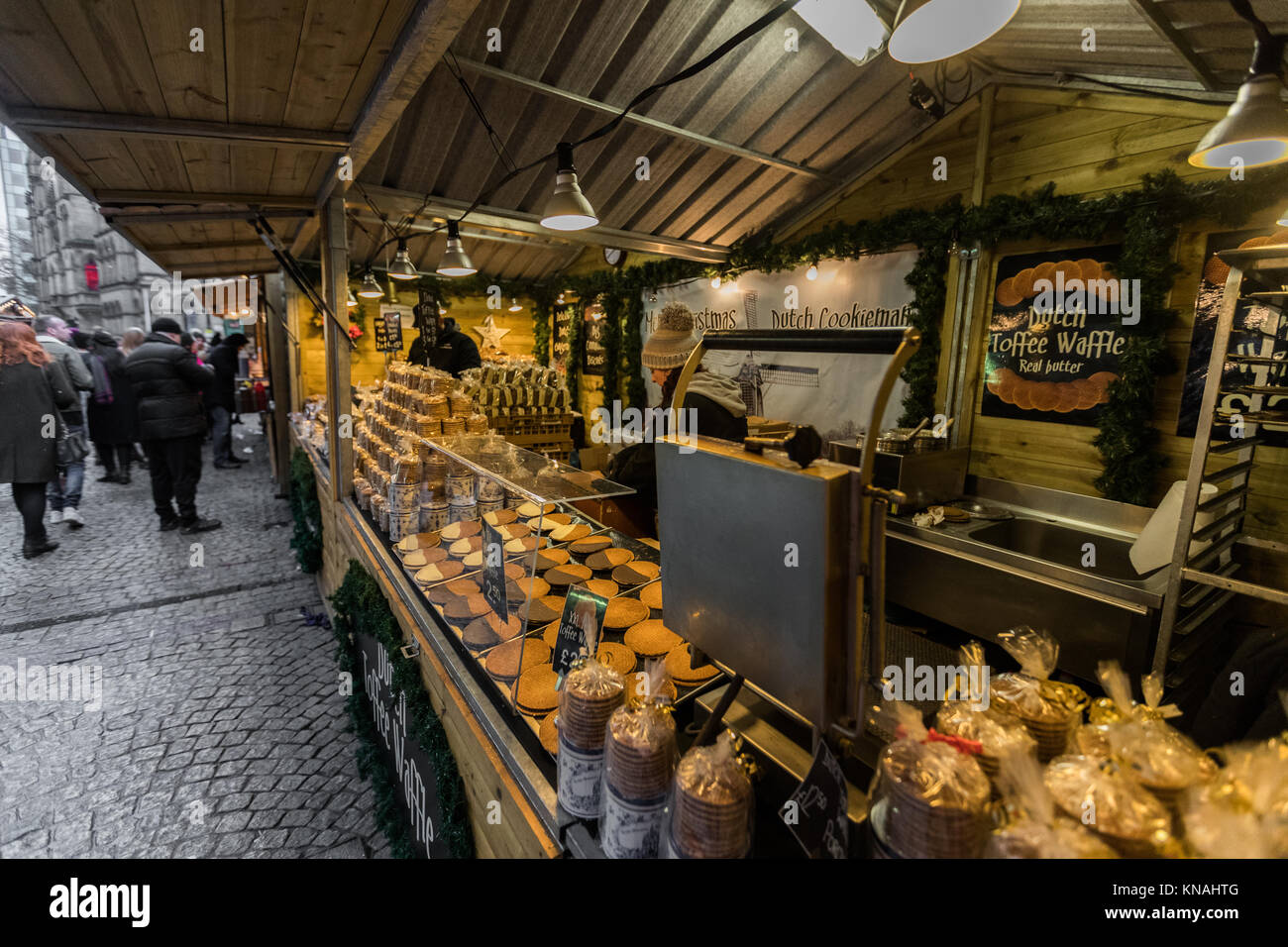 Market stall traders serve food and drink to customers at Manchester ...