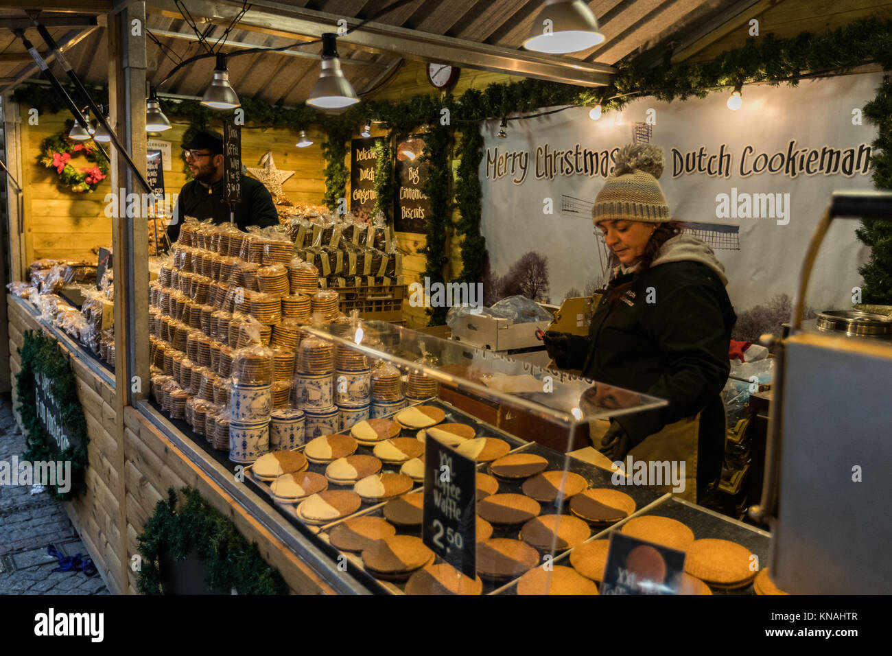 Market stall traders serve food and drink to customers at Manchester ...