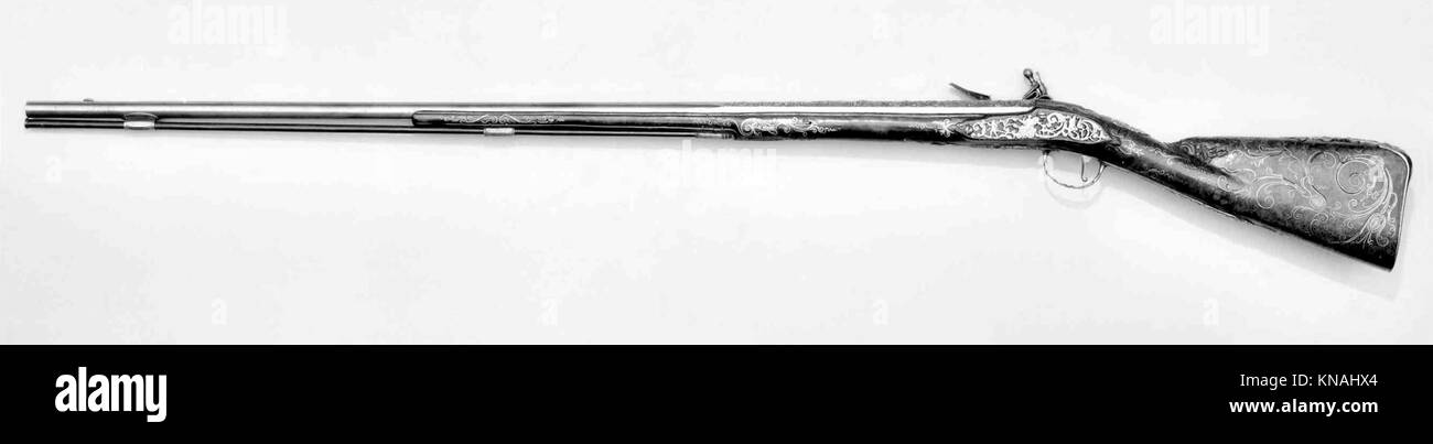 This 18th-century flintlock gun with wooden stock and metal components ...