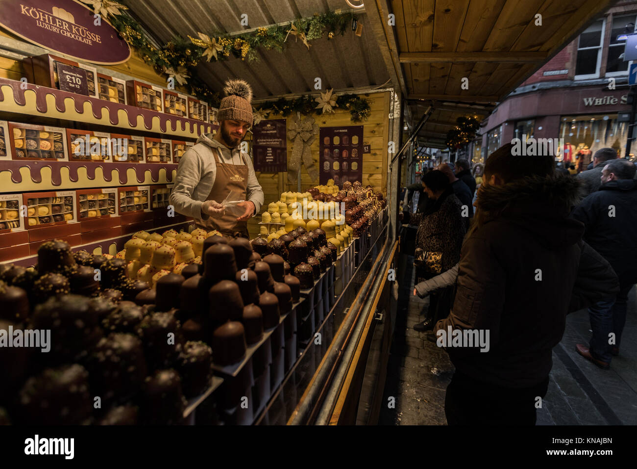Market stall traders serve food and drink to customers at Manchester ...