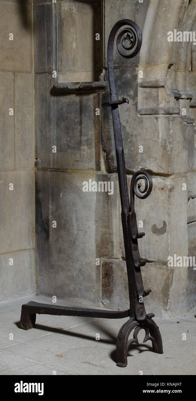 A pair of andirons, designed for use in a fireplace to hold logs ...