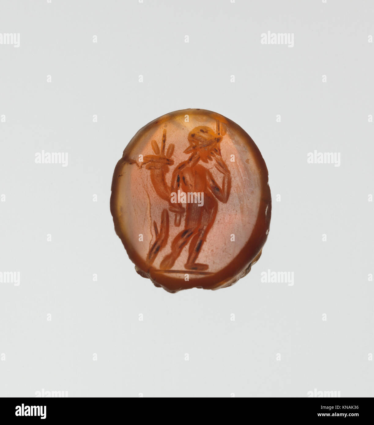 A carnelian scarab featuring Harpocrates with a cornucopia, cataloged ...