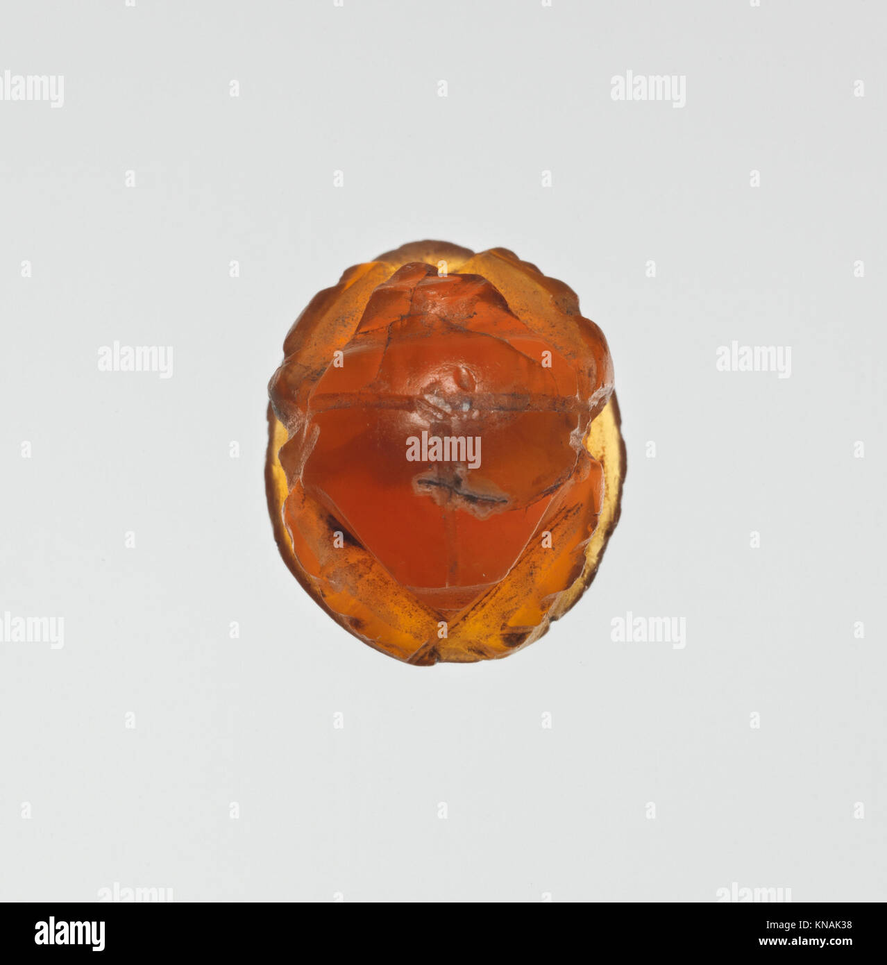 The carnelian scarab shows Harpocrates with a cornucopia, representing ...