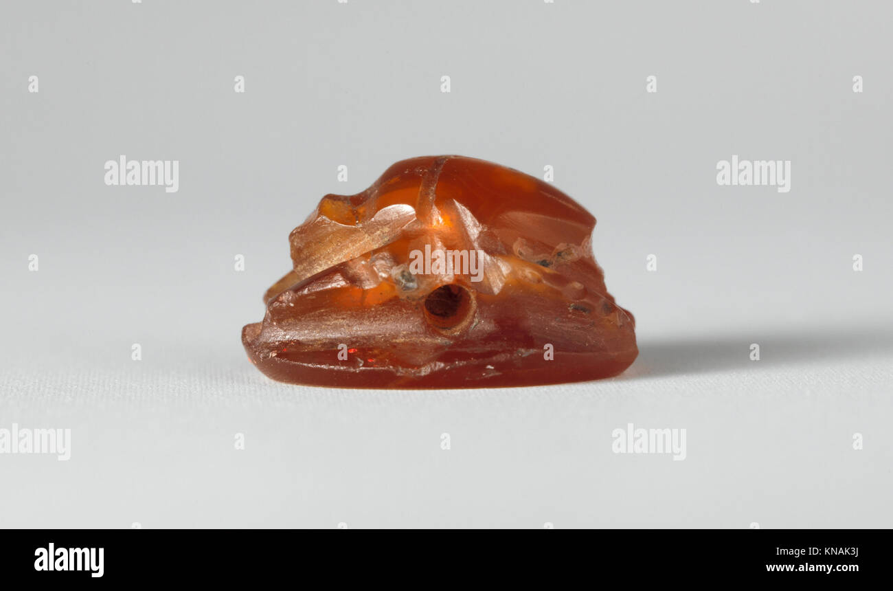 This carnelian scarab features the figure of Harpocrates with a ...