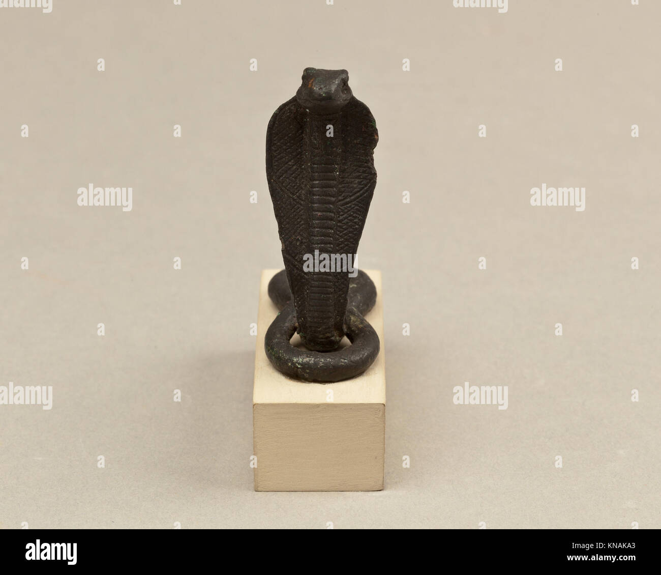 This sculpture of a coiled and rearing cobra captures the dynamic pose ...