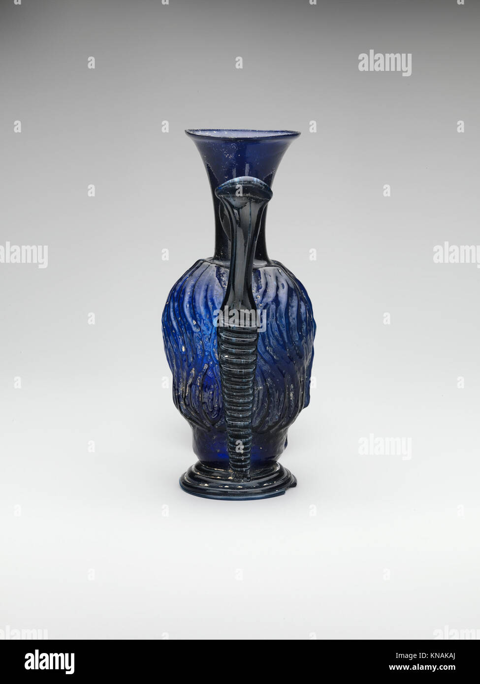 This glass head flask is a decorative and functional vessel, crafted ...