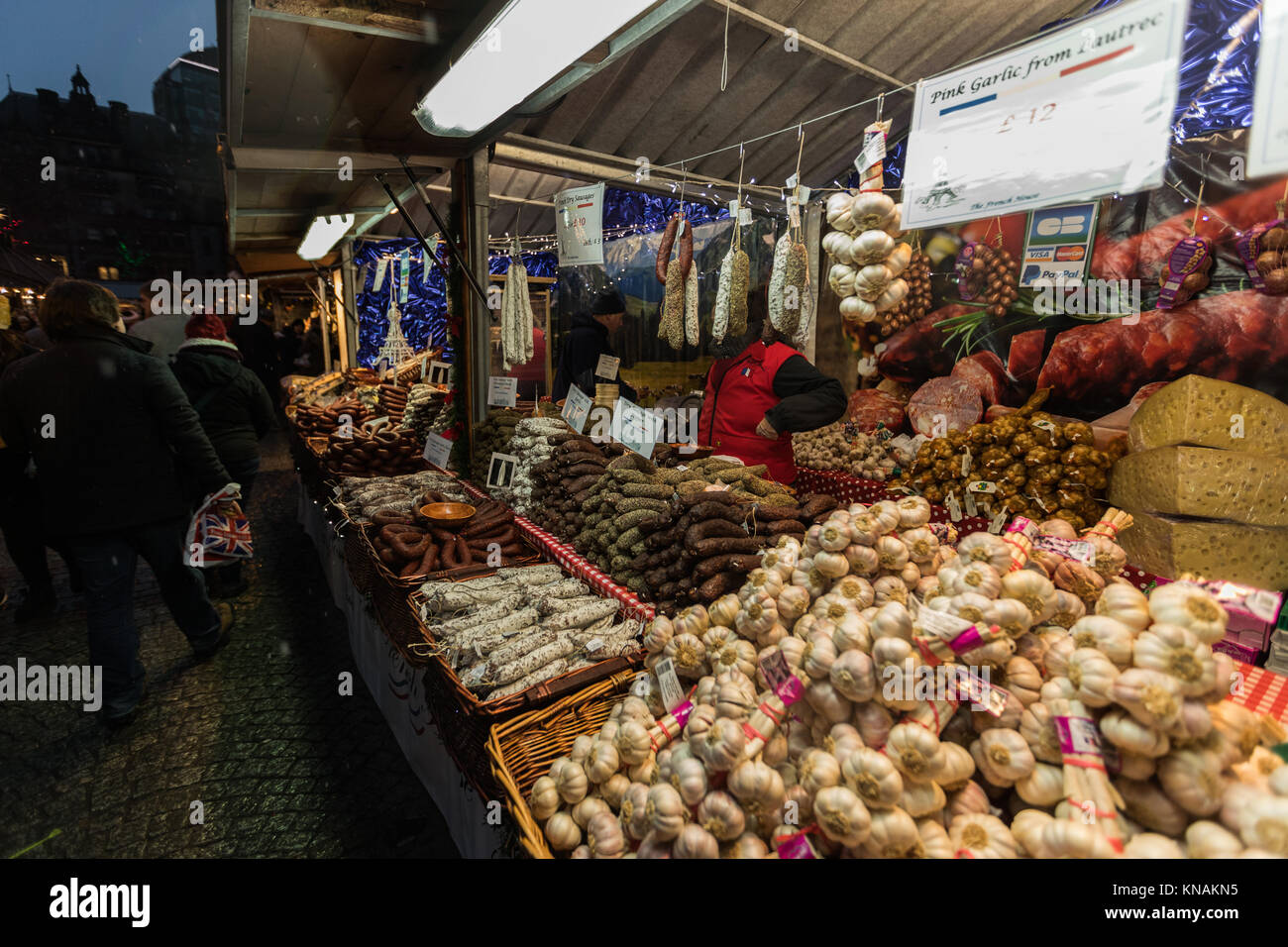 Market stall traders serve food and drink to customers at Manchester ...